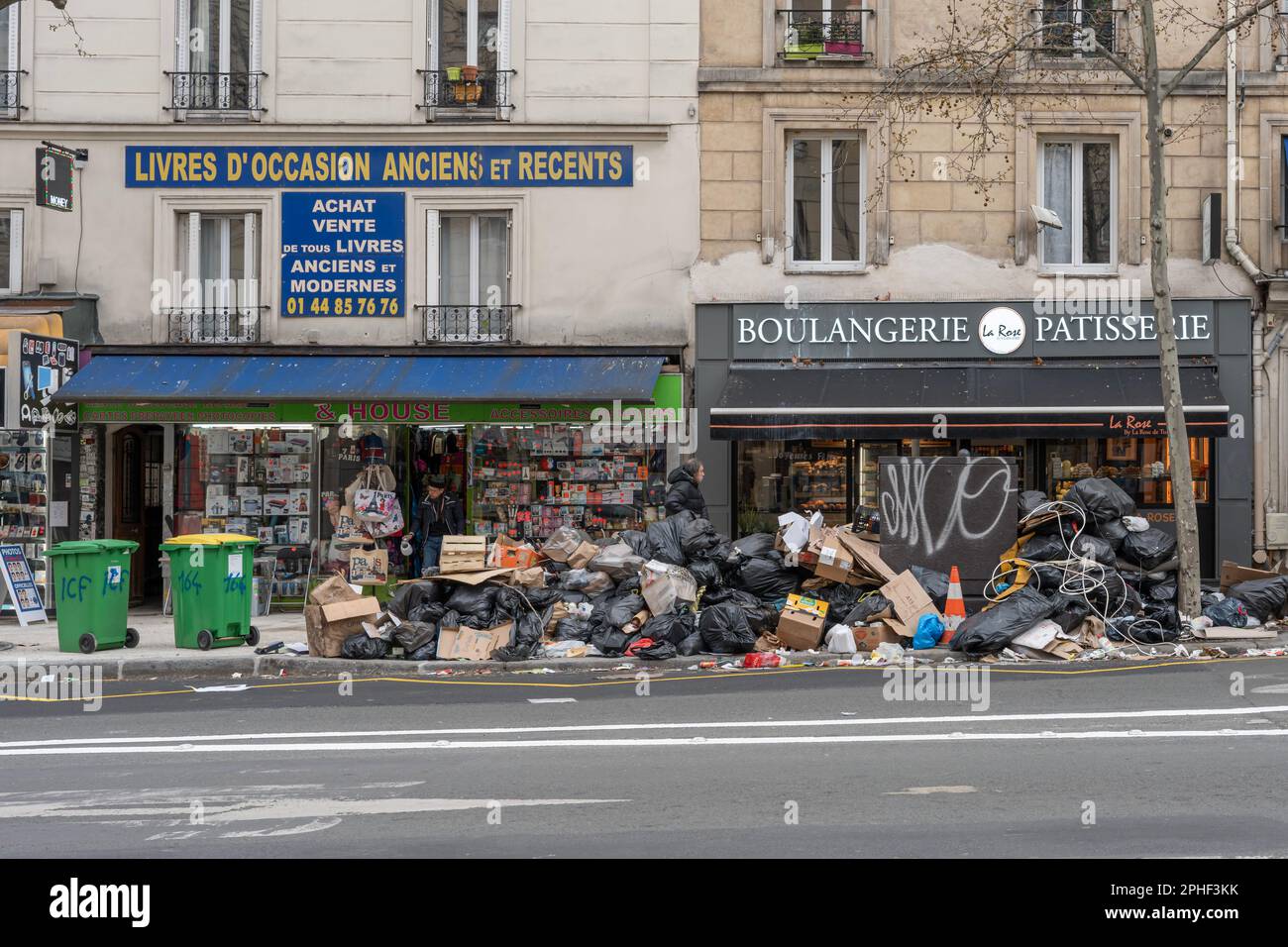 Paris, France - 03 28 2023: Garbage cans left on the public highway ...