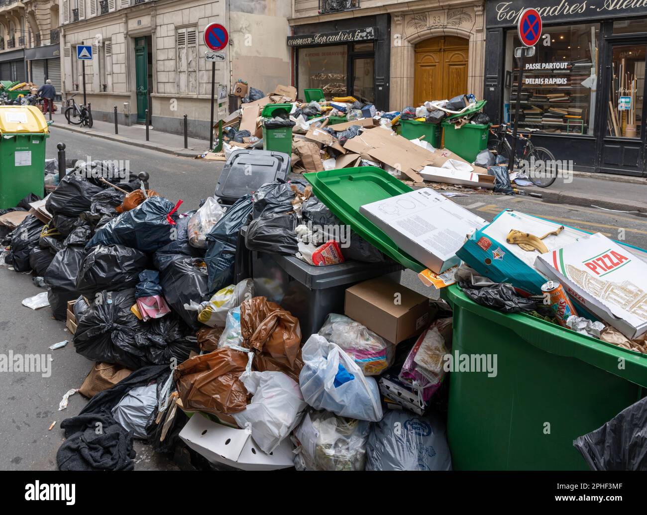 Paris, France - 03 28 2023: Garbage cans left on the public highway ...