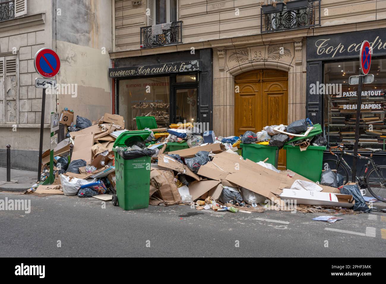 Paris, France - 03 28 2023: Garbage cans left on the public highway ...