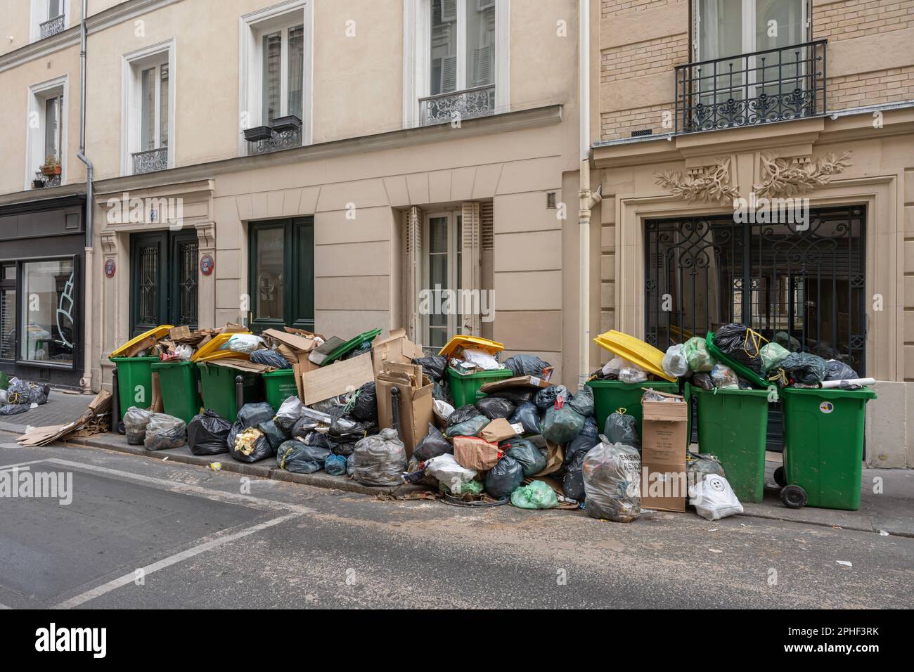 Paris, France - 03 28 2023: Garbage cans left on the public highway ...