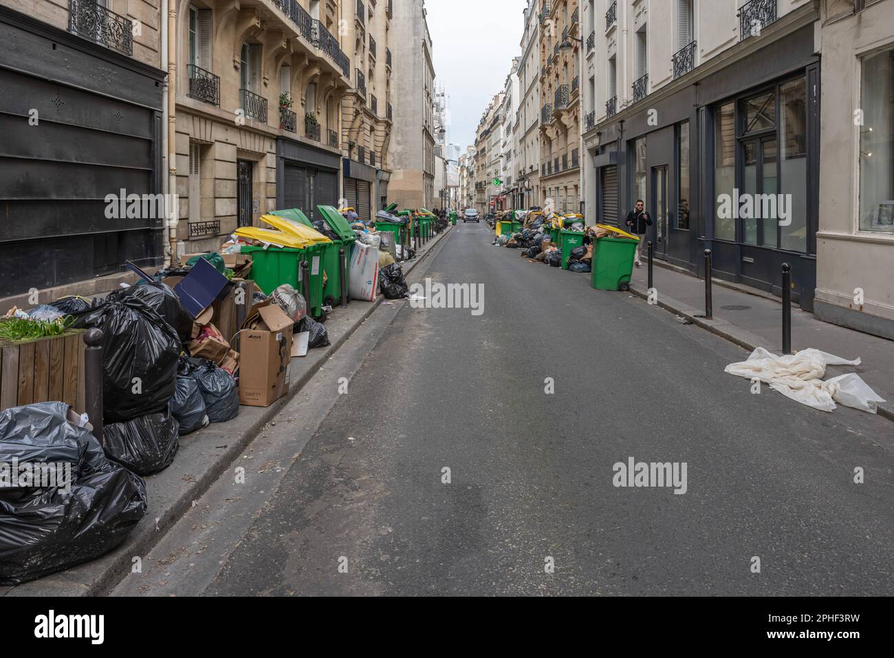 Paris, France - 03 28 2023: Garbage cans left on the public highway ...