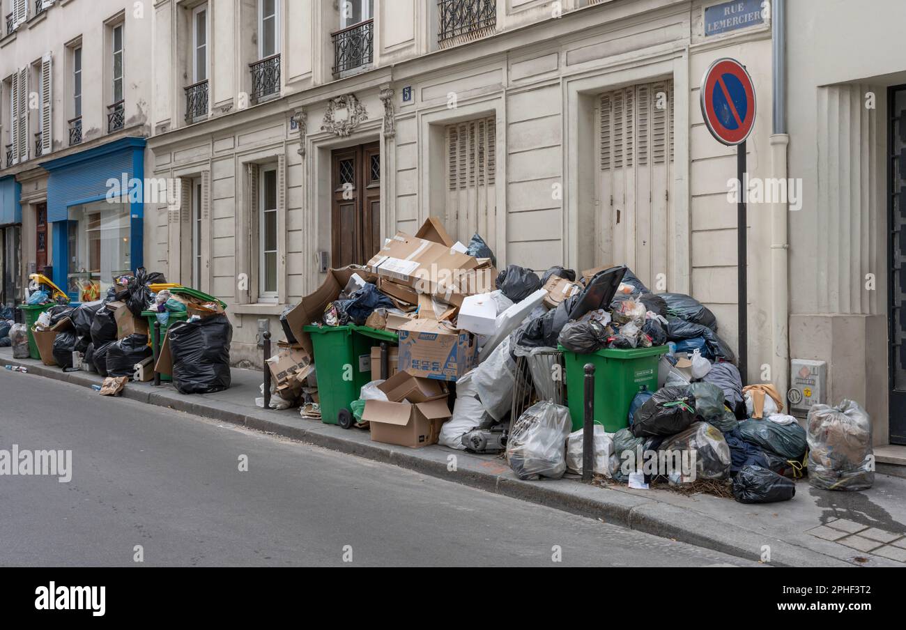 Paris, France - 03 28 2023: Garbage cans left on the public highway ...