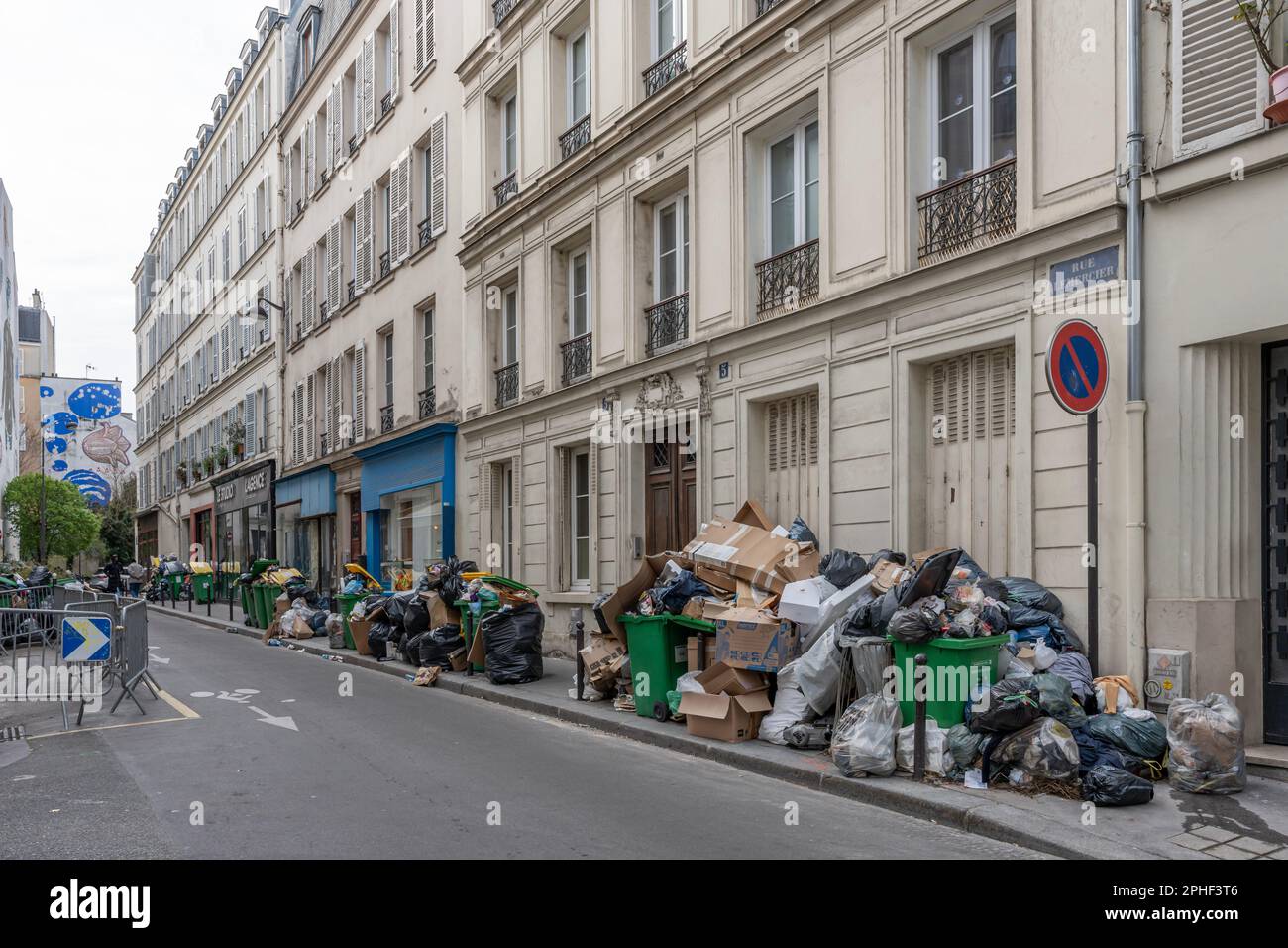 Paris, France - 03 28 2023: Garbage cans left on the public highway ...