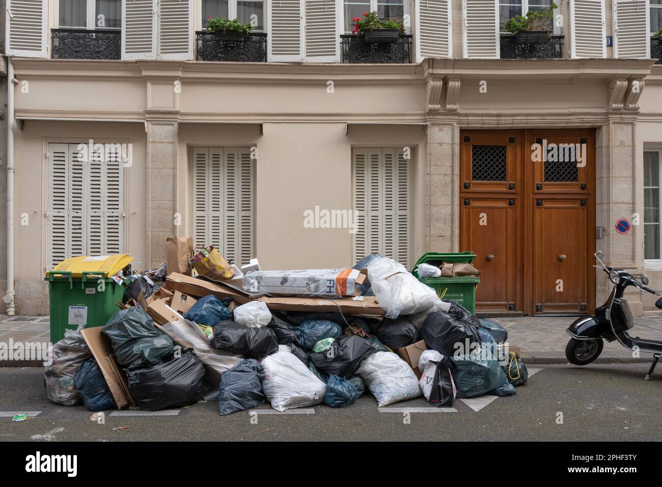 Paris, France - 03 28 2023: Garbage cans left on the public highway ...