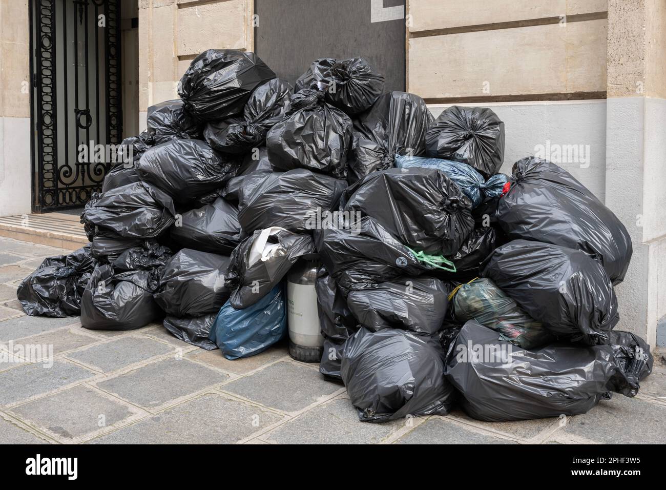 Paris, France - 03 28 2023: Garbage cans left on the public highway ...