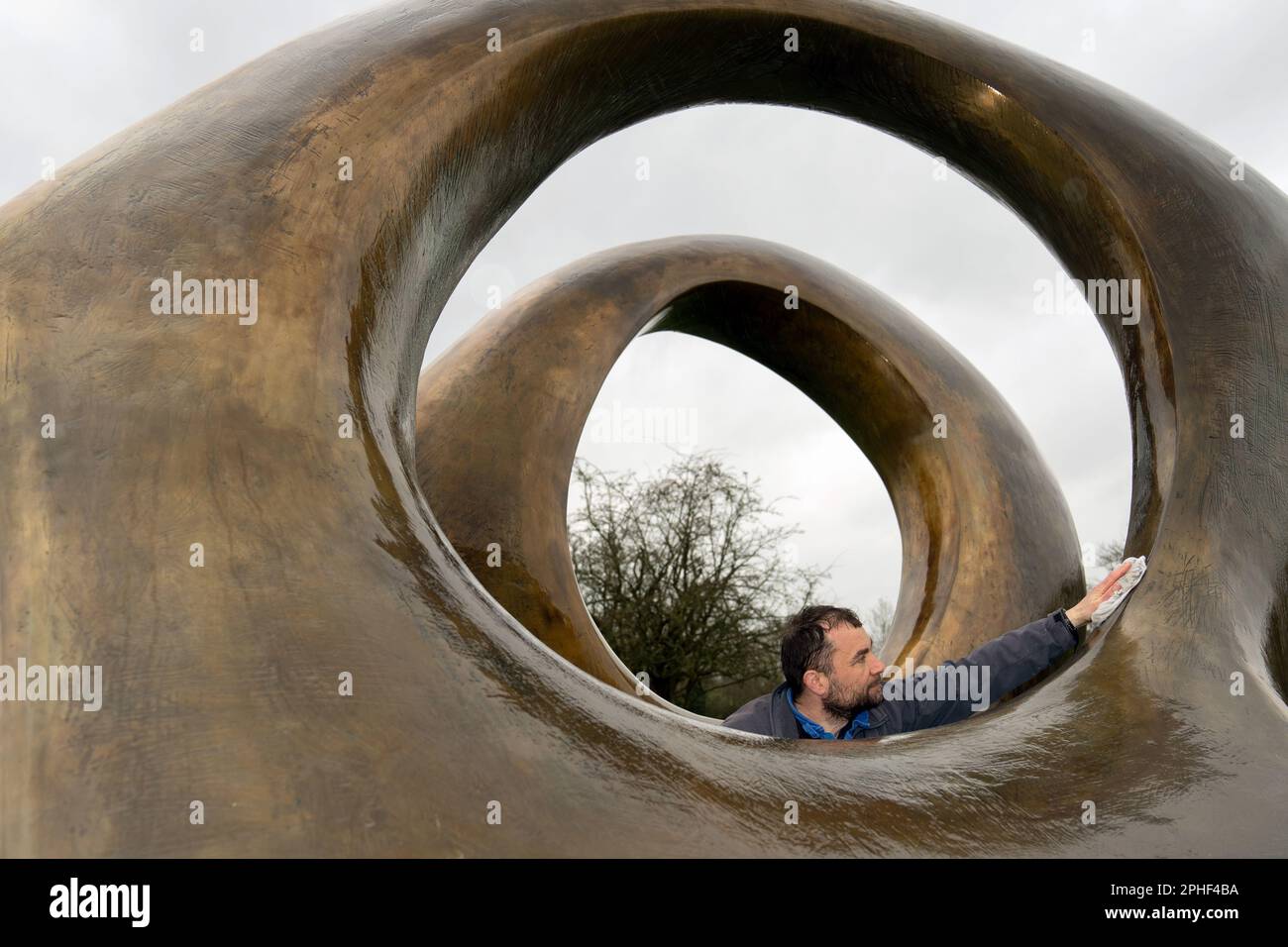 Sculpture technician Dai Roberts clean and dries the bronze sculpture ...