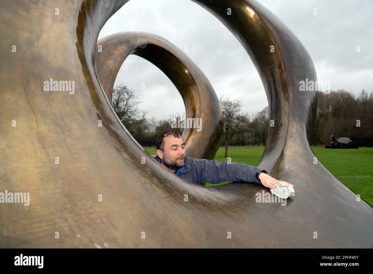Sculpture technician Dai Roberts clean and dries the bronze sculpture ...