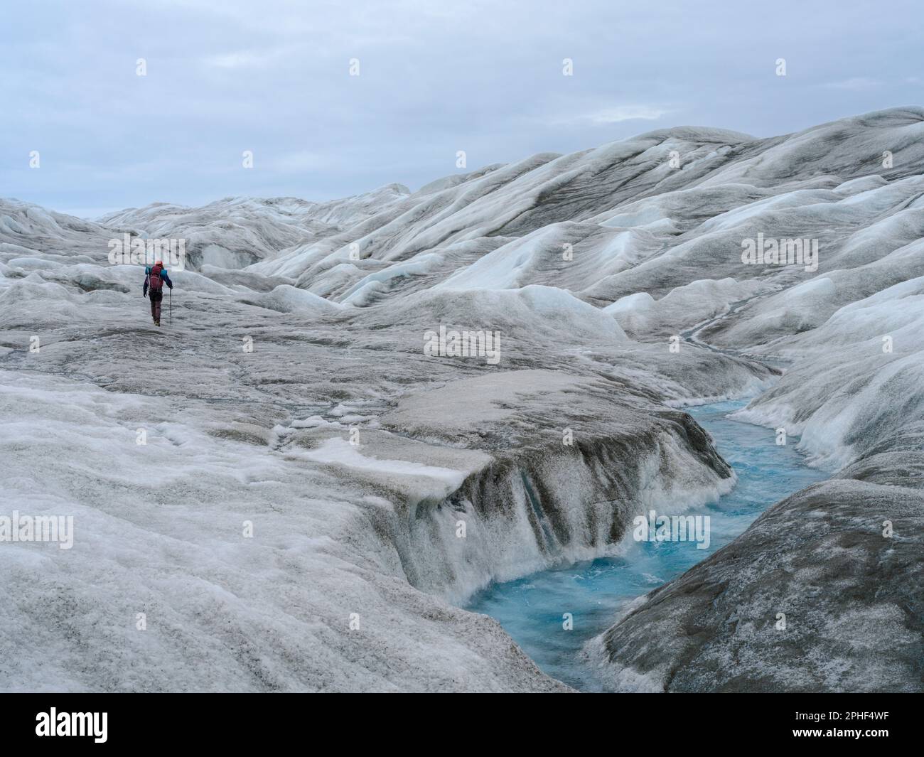 Tourists hiking on the ice. The brown sediment on the ice is created by ...