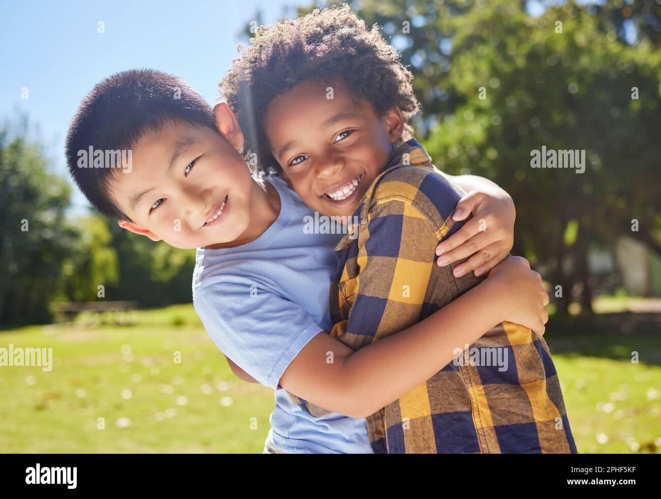 Portrait, children and friends hugging in a park together for fun ...