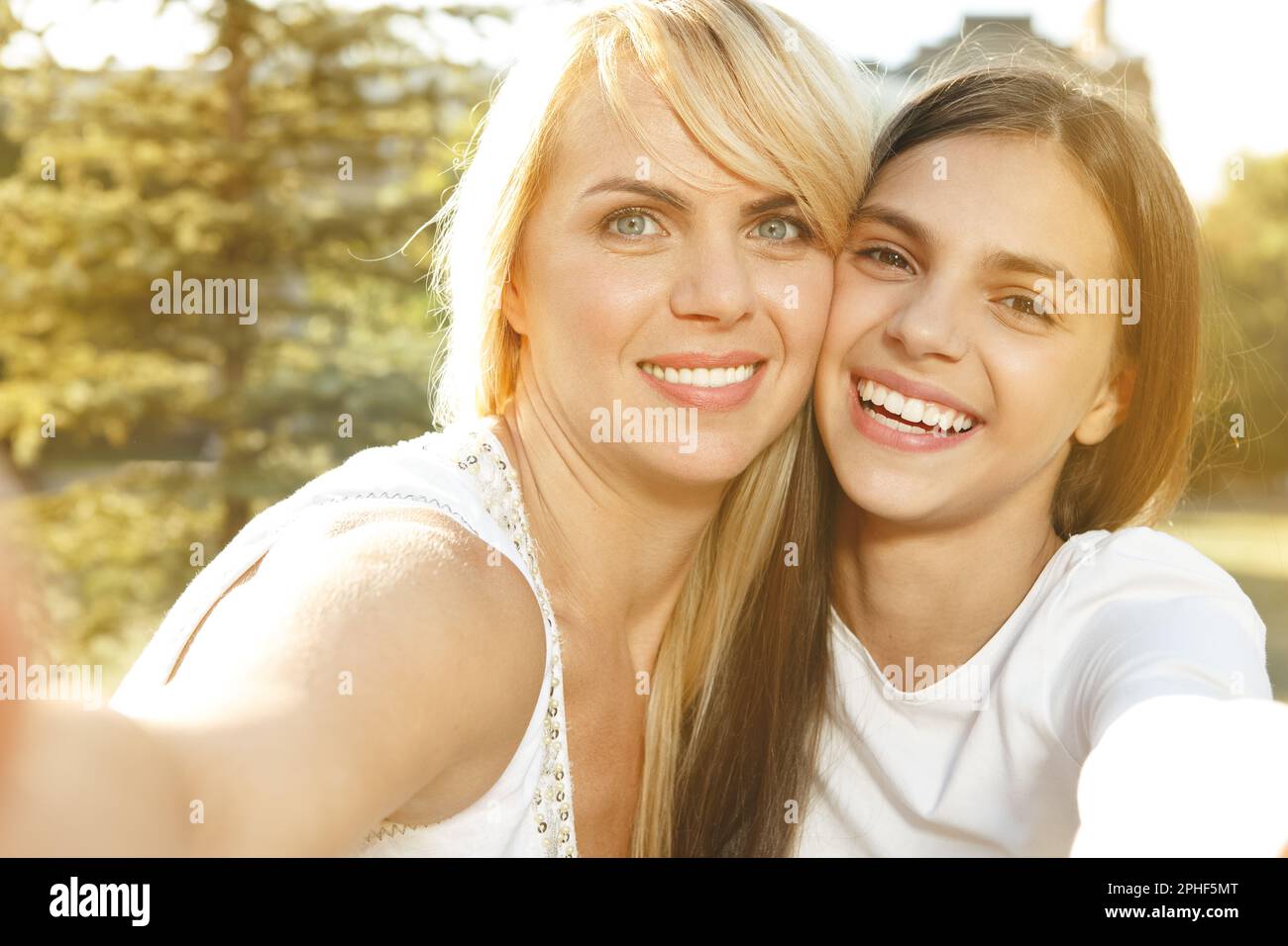 Happy mom and daughter taking selfie together Stock Photo - Alamy