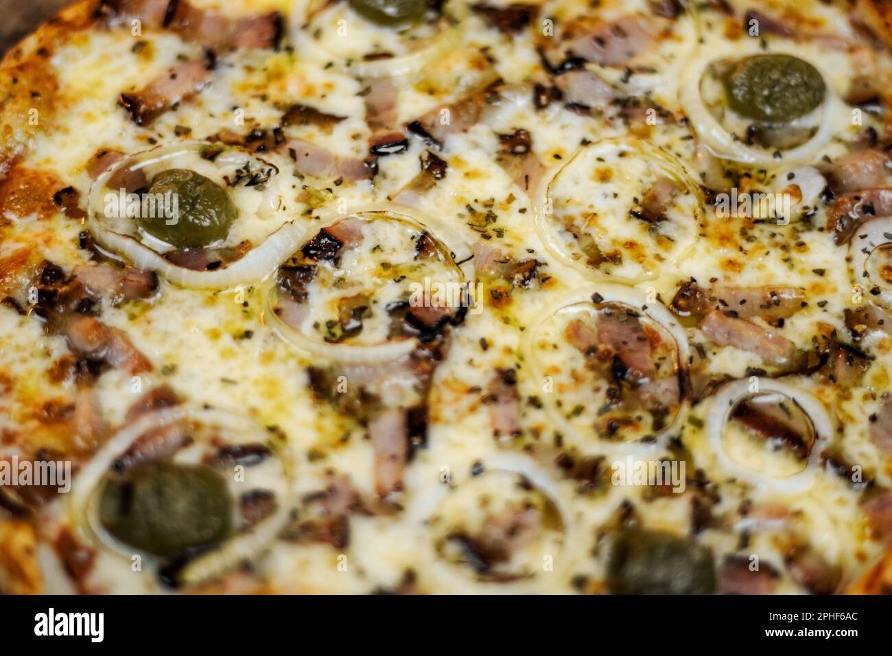 A delicious-looking pizza is presented on a table, topped with an ...