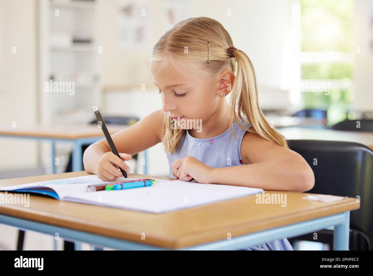 Education, drawing and girl in classroom learning, exam or studying ...