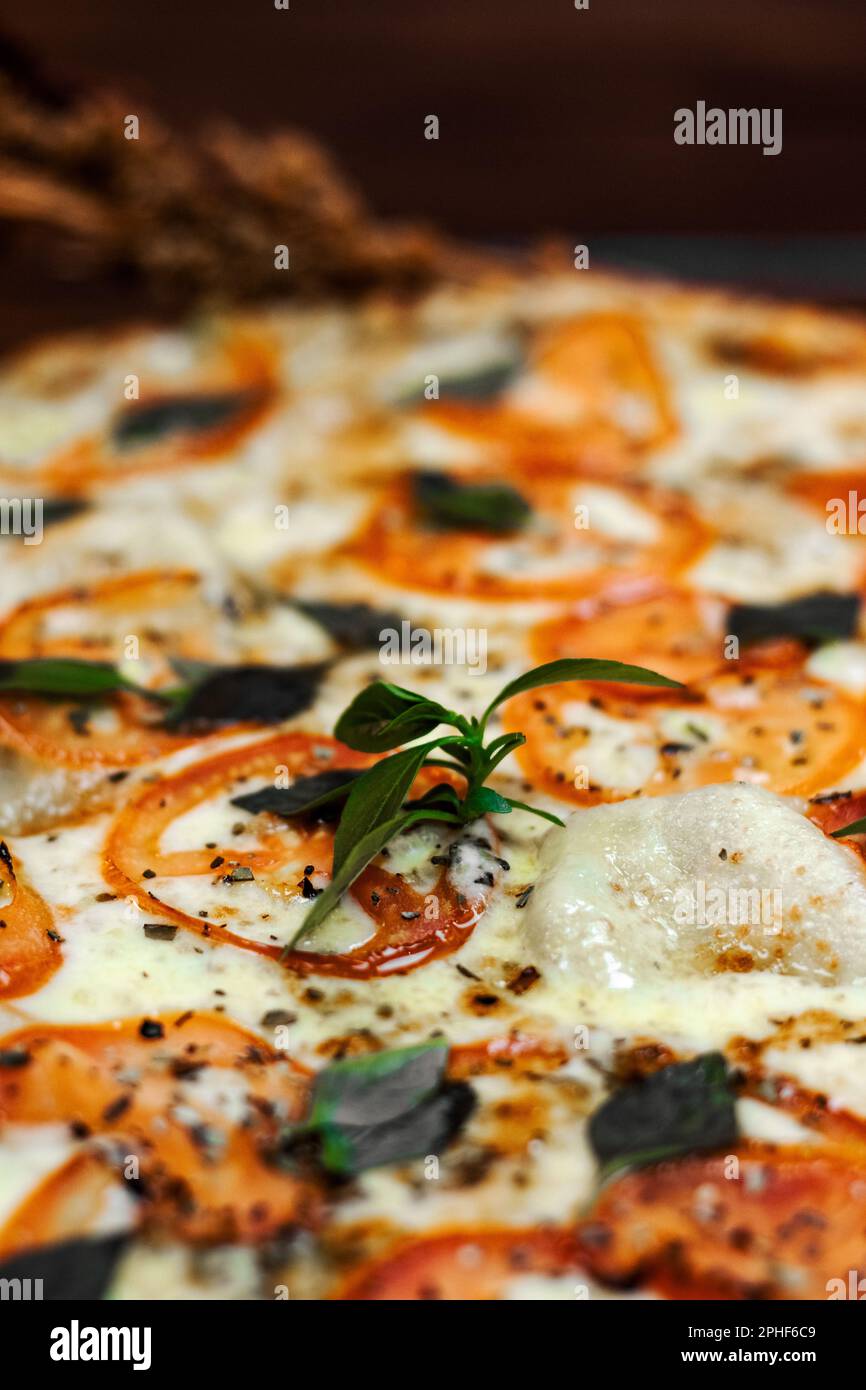 A freshly made pizza with fresh basil topping, ready to be enjoyed ...