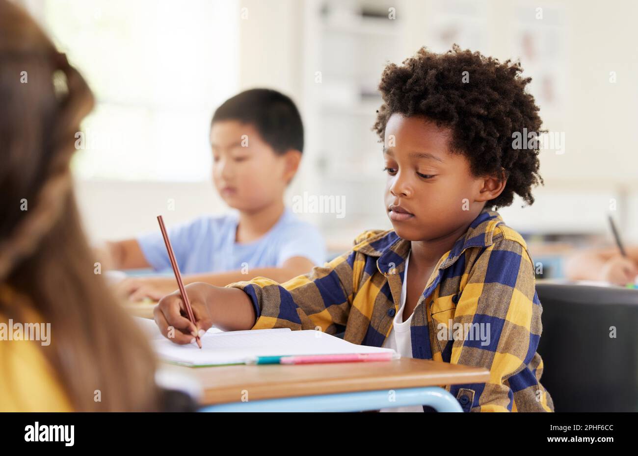 .Education, writing and black boy in classroom learning, exam or ...