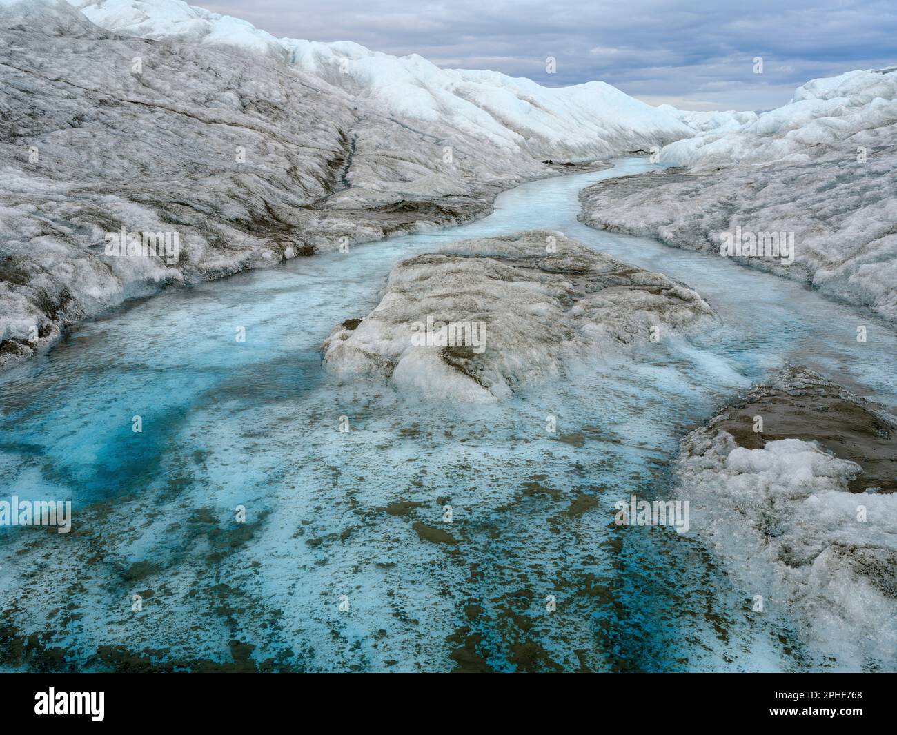 Drainage system on the surface of the ice sheet. The brown sediment on ...