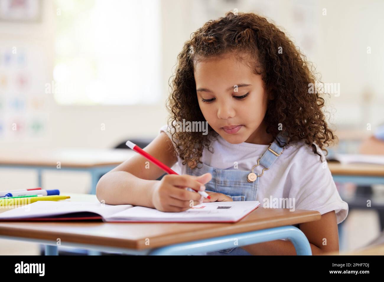 Learning, drawing and girl in classroom for education, exam or studying ...