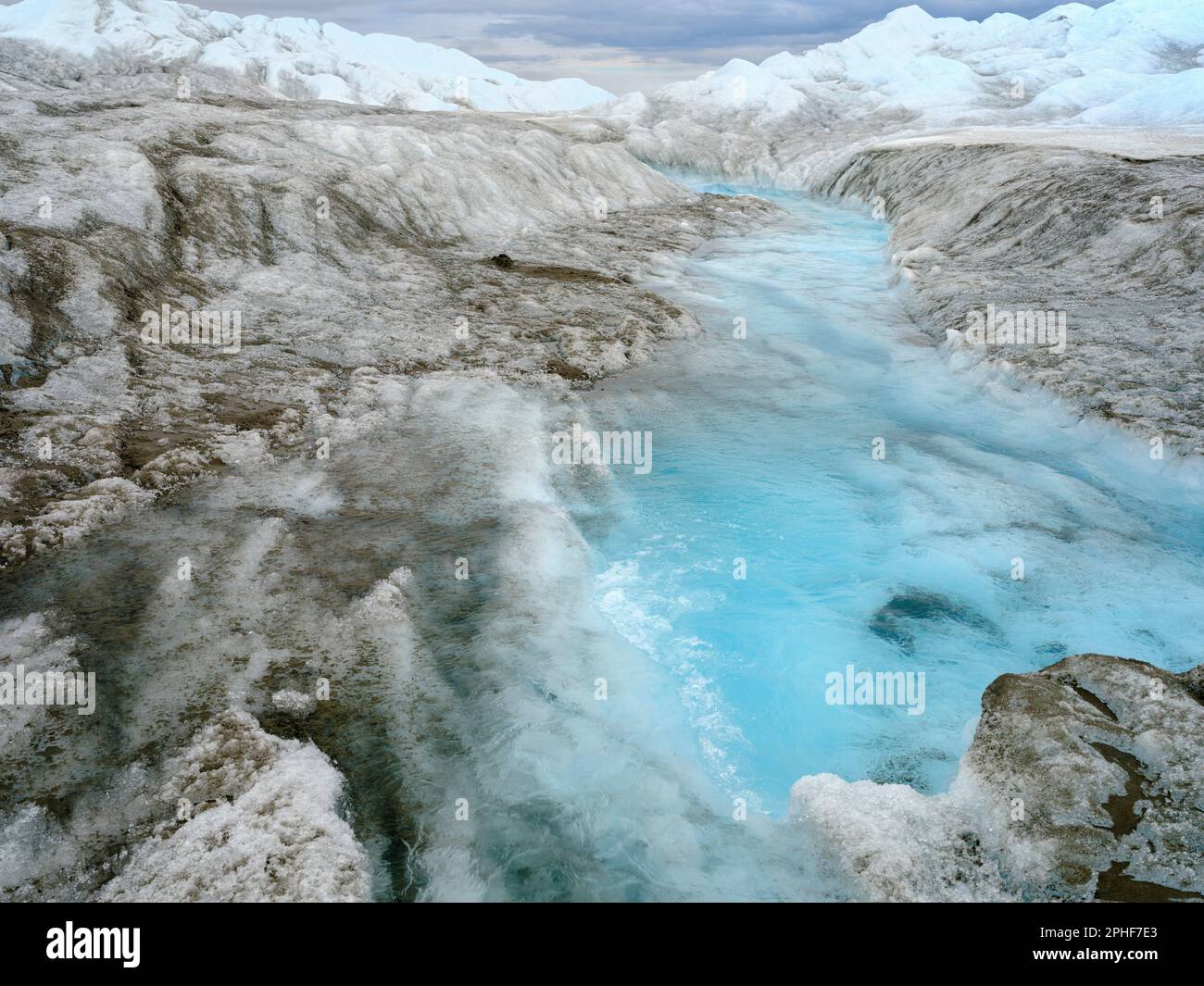 Drainage system on the surface of the ice sheet. The brown sediment on ...