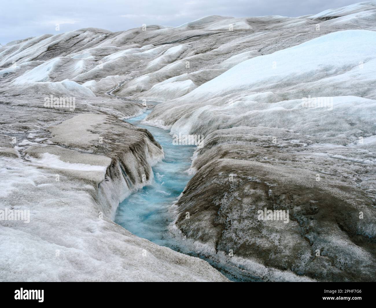 Drainage system on the surface of the ice sheet. The brown sediment on ...