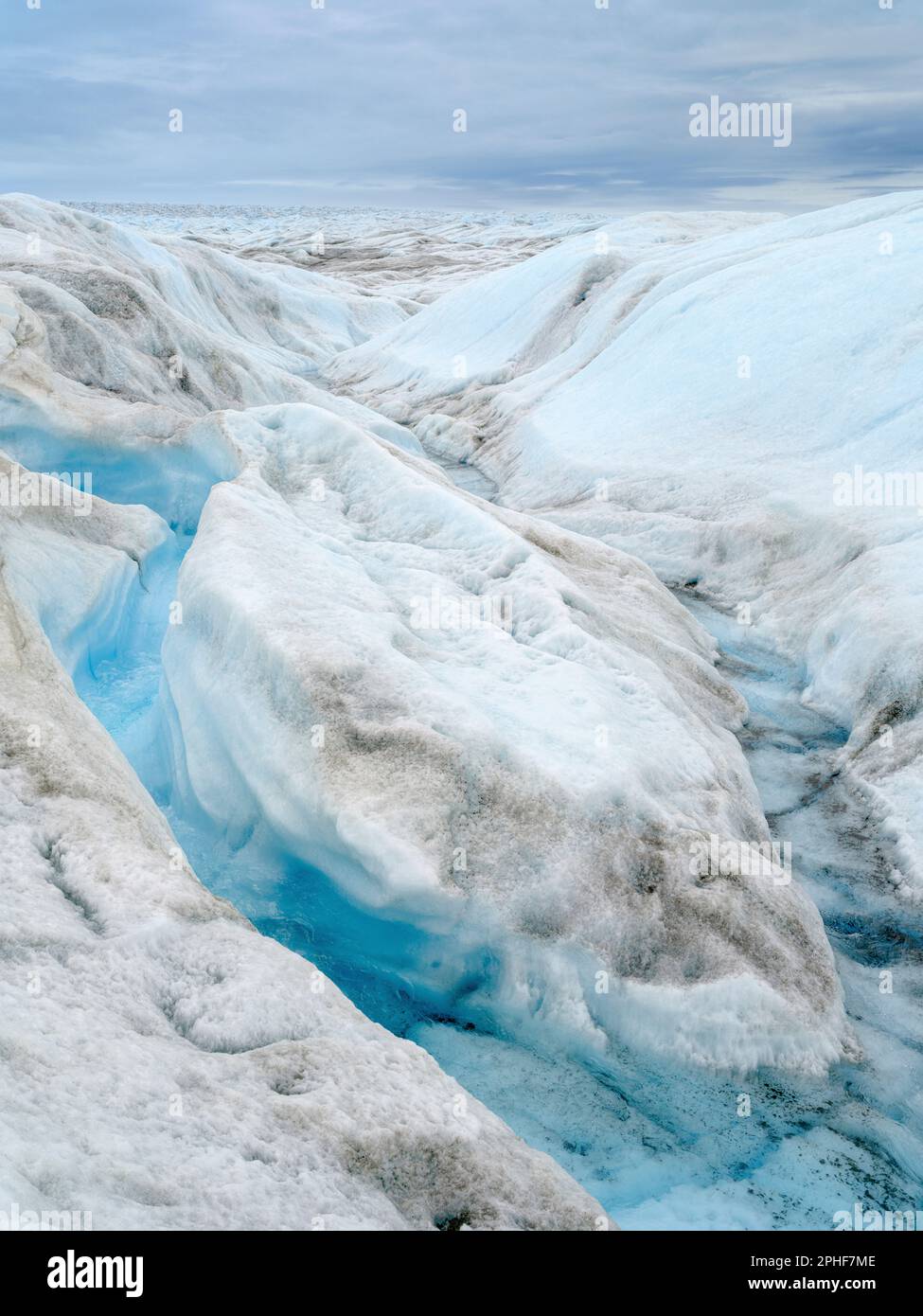 Drainage system on the surface of the ice sheet. The brown sediment on ...