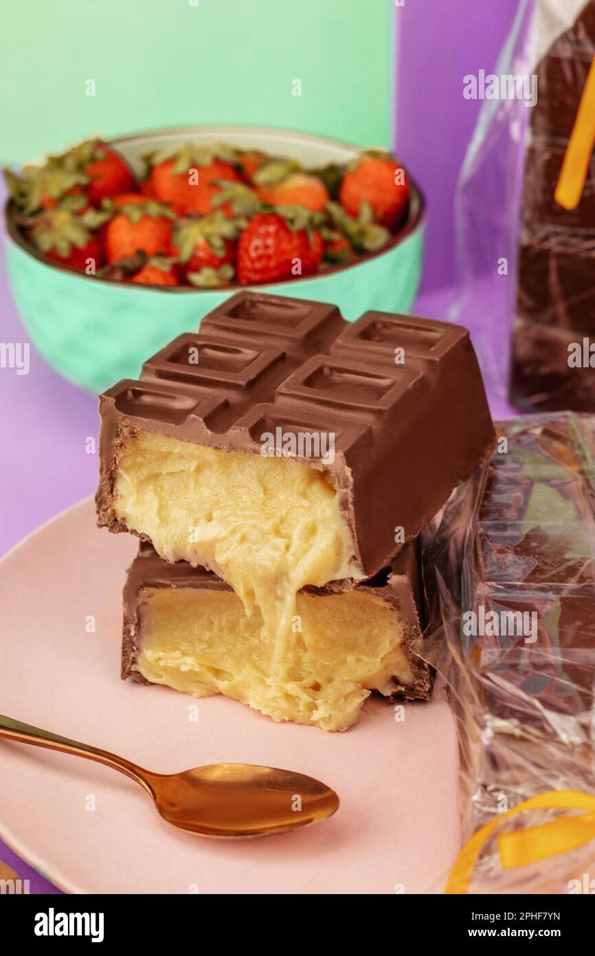 A vertical image of a large chocolate bar with a creamy, gooey center ...