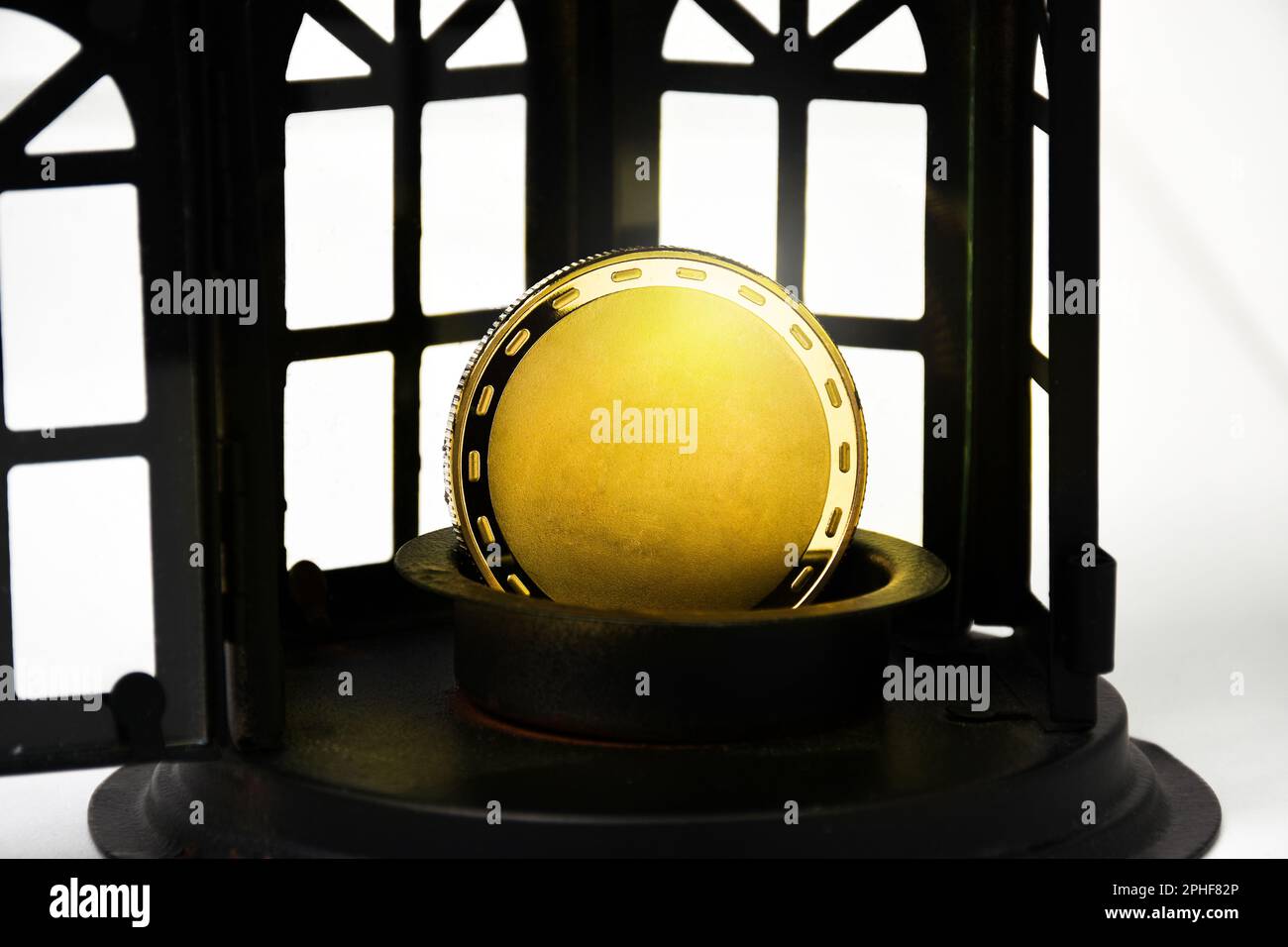 Blank gold coins in a metal pedestal with a black window on a white ...