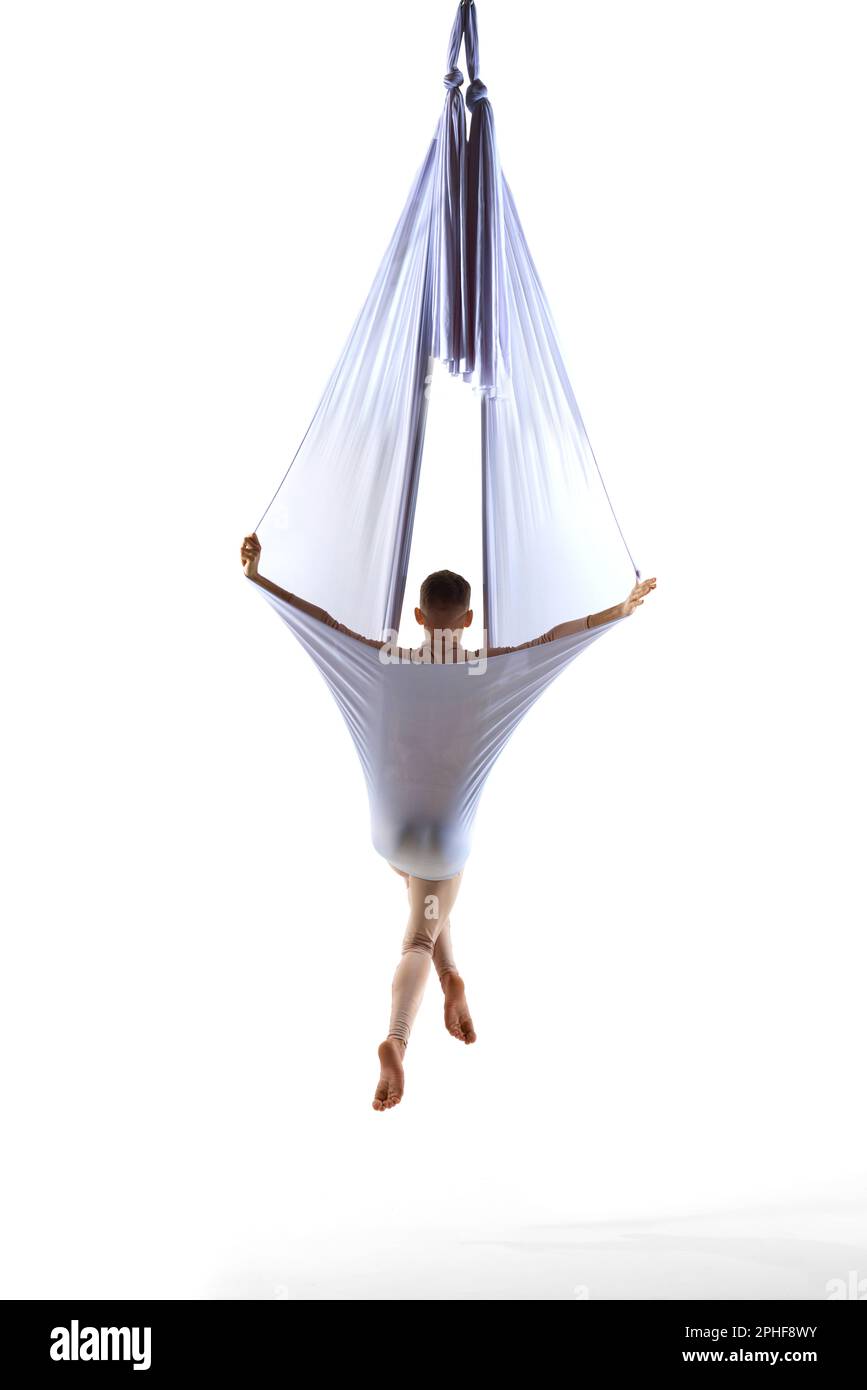 Professional male aerial gymnast training with transparent silk fabric ...
