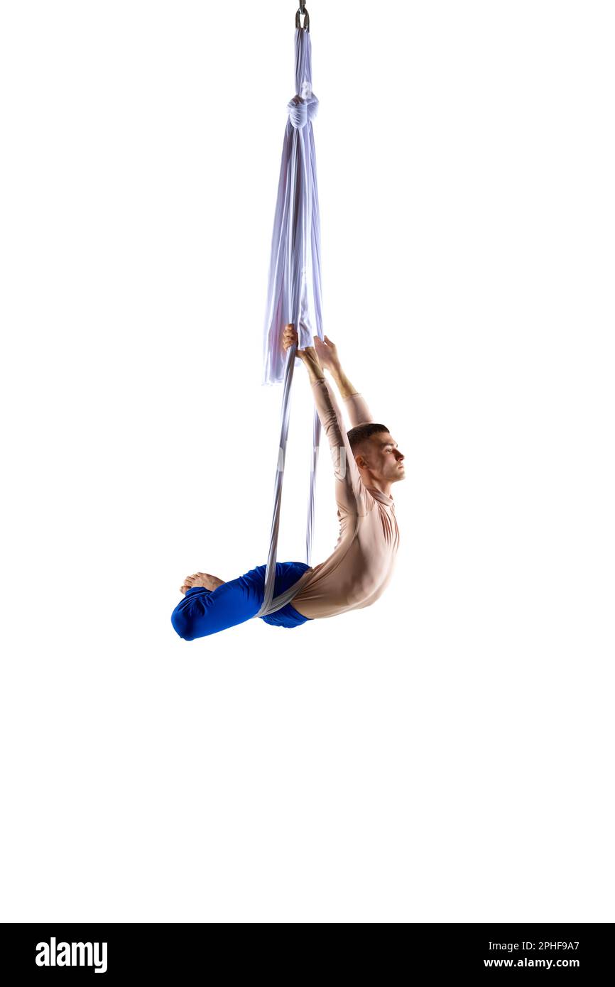 Strong, athletic young man, professional aerial gymnast, acrobat ...