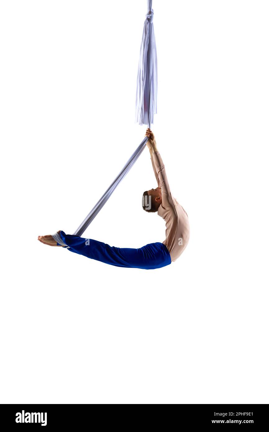 Acrobatic movements. Young man, professional aerial gymnast flying on ...