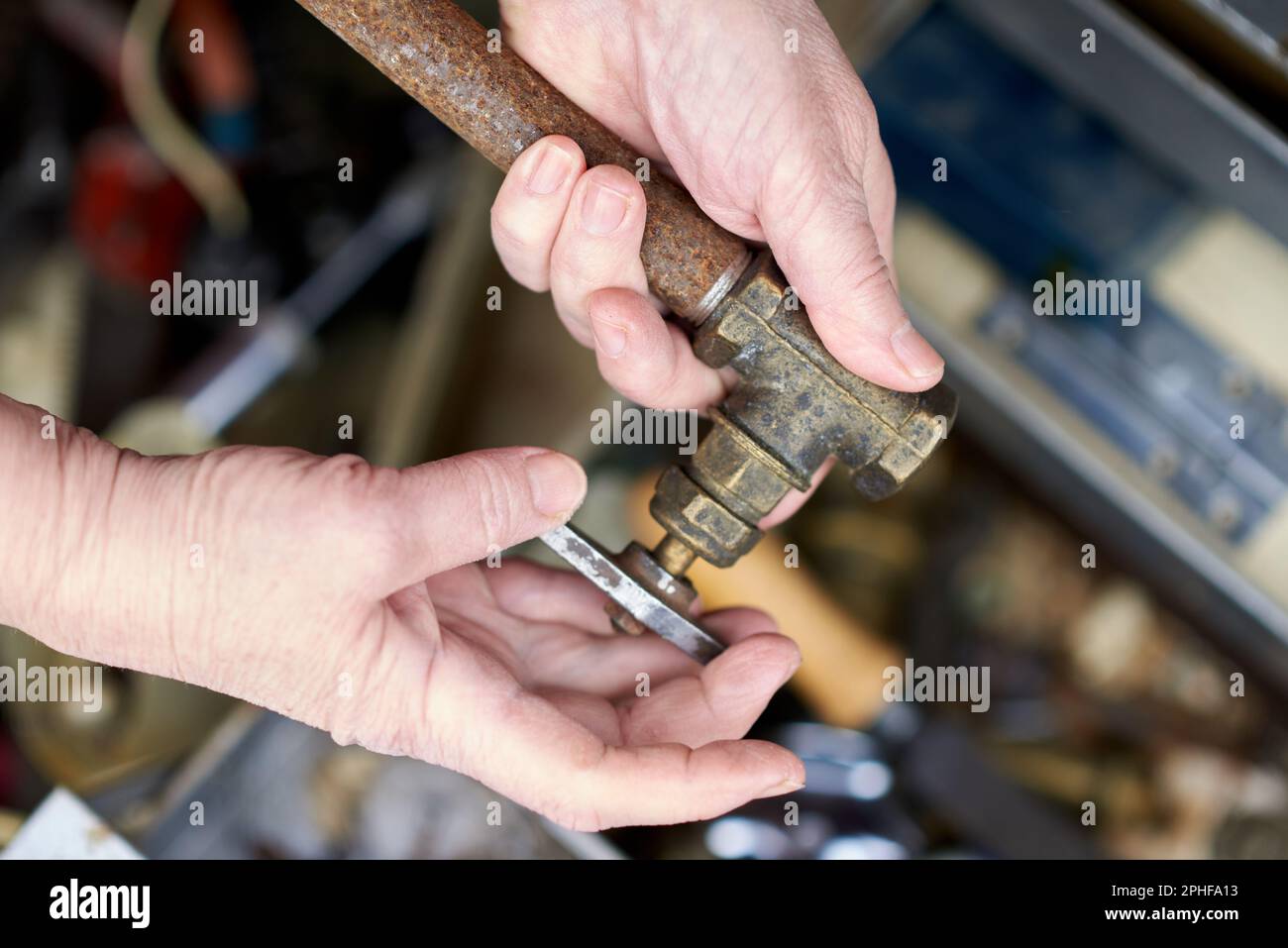 A man is holding an old water pipe valve in his hands Stock Photo - Alamy