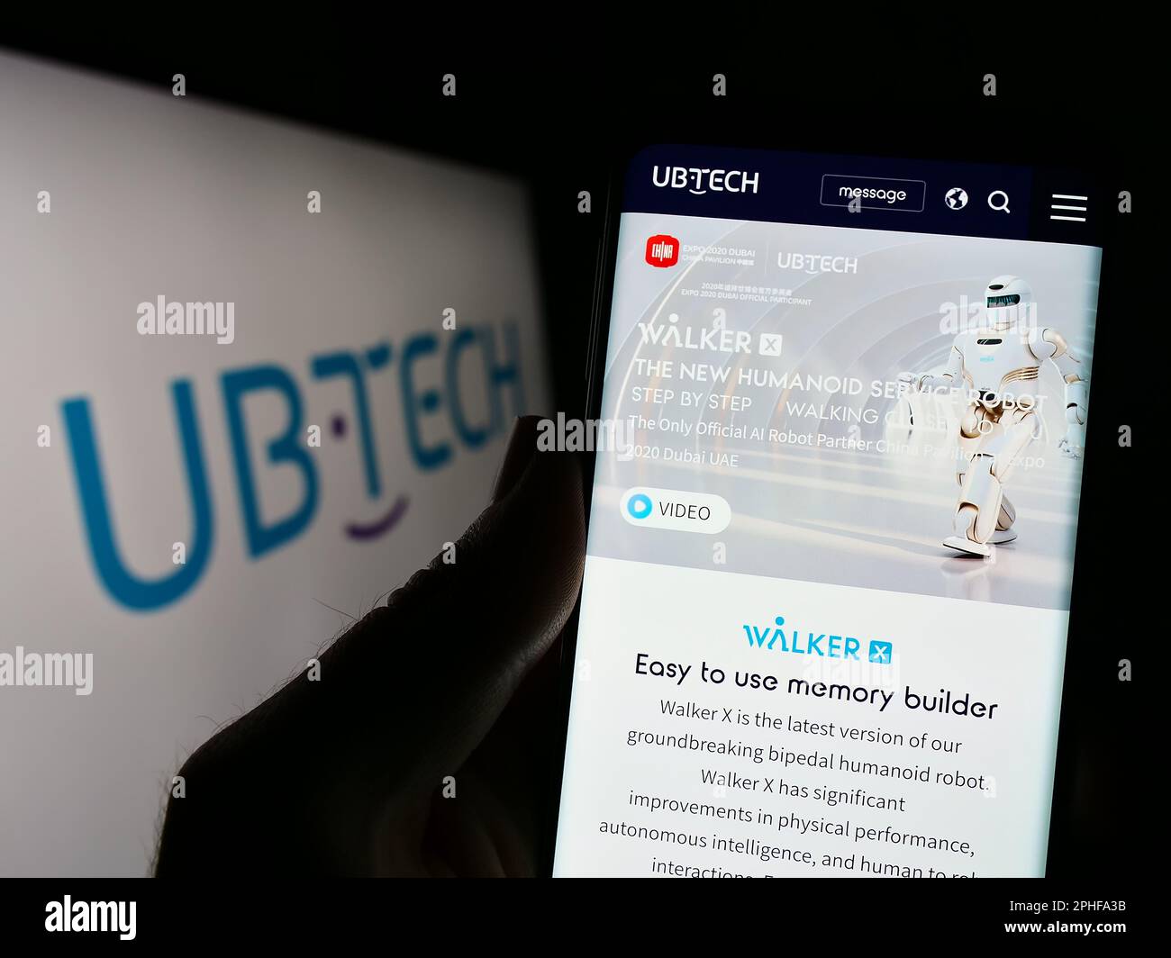 Person holding smartphone with webpage of Chinese company UBTech ...