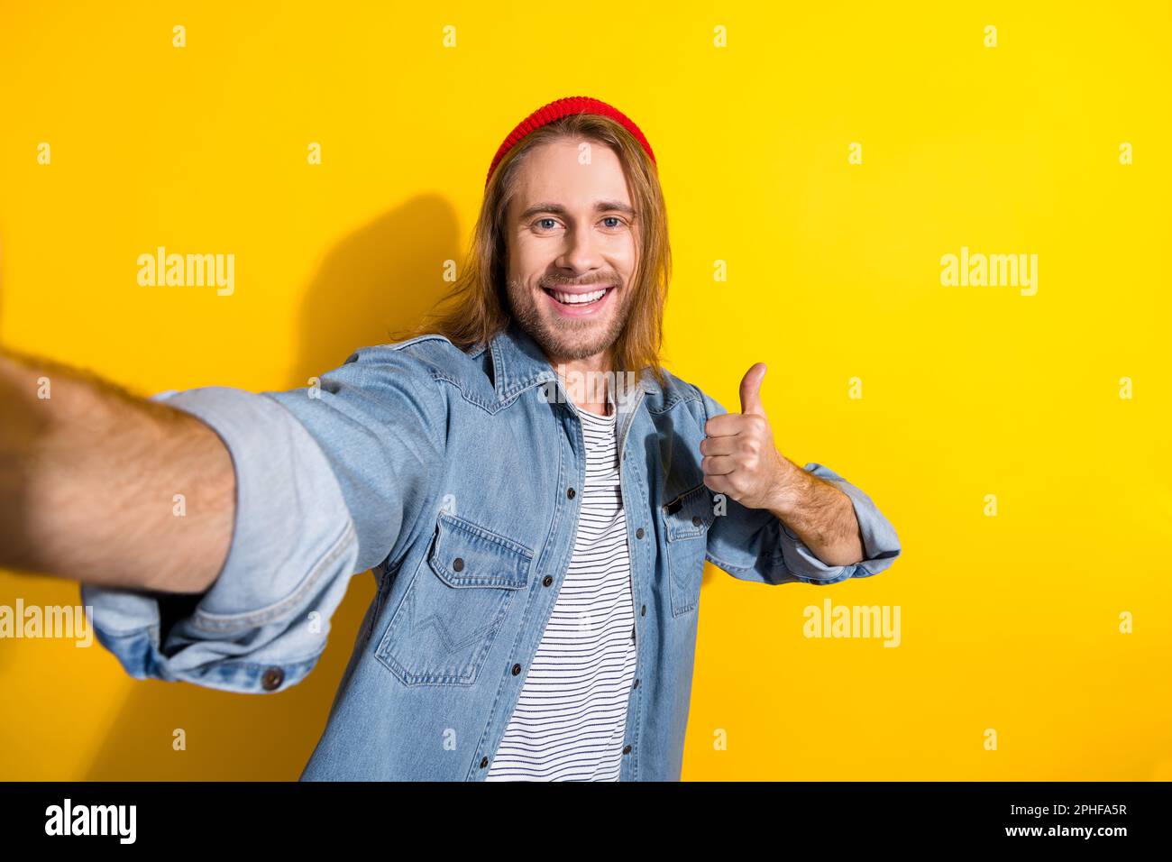 Photo of positive cool man wear denim jacket showing thumb up tacking ...