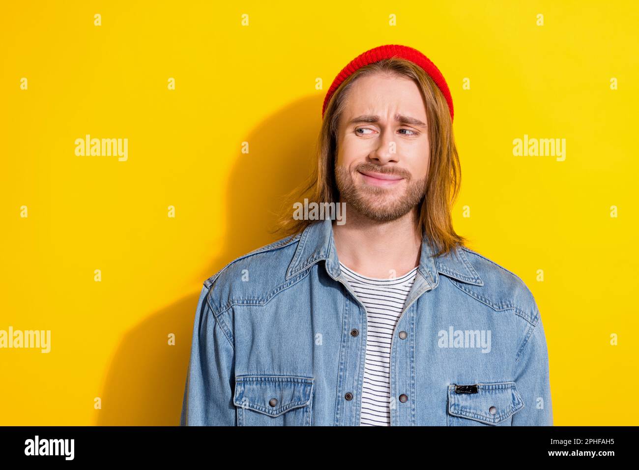 Portrait of confused funny guy with bob haircut wear denim jacket looks ...