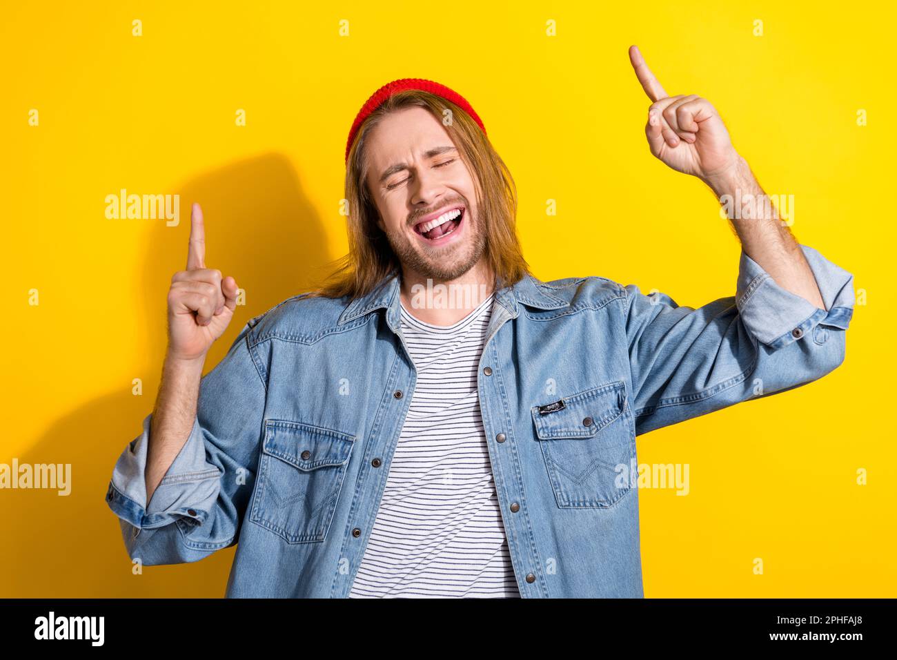 Photo of handsome funky guy with long hairdo dressed jeans shirt ...