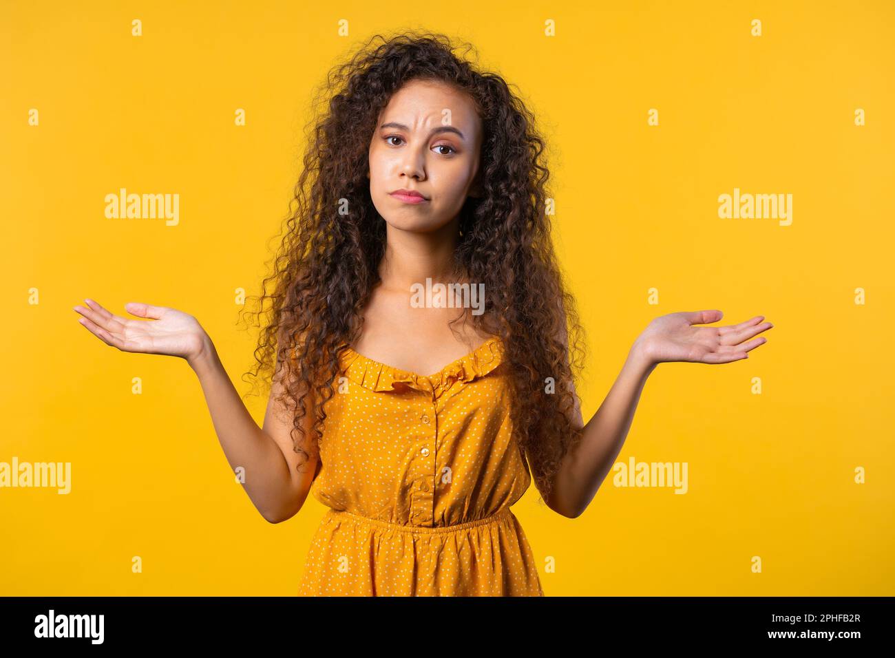 Confused pretty woman, shoulders up - can't help, makes gesture of I ...
