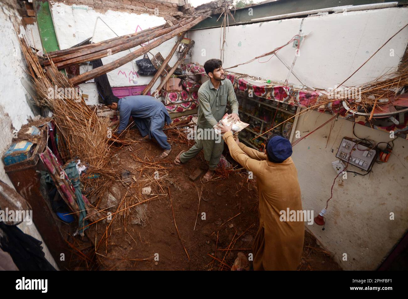 People inspect the damaged room after the roof collapsed in Bhanwari ...
