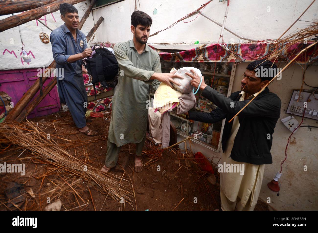 People inspect the damaged room after the roof collapsed in Bhanwari ...