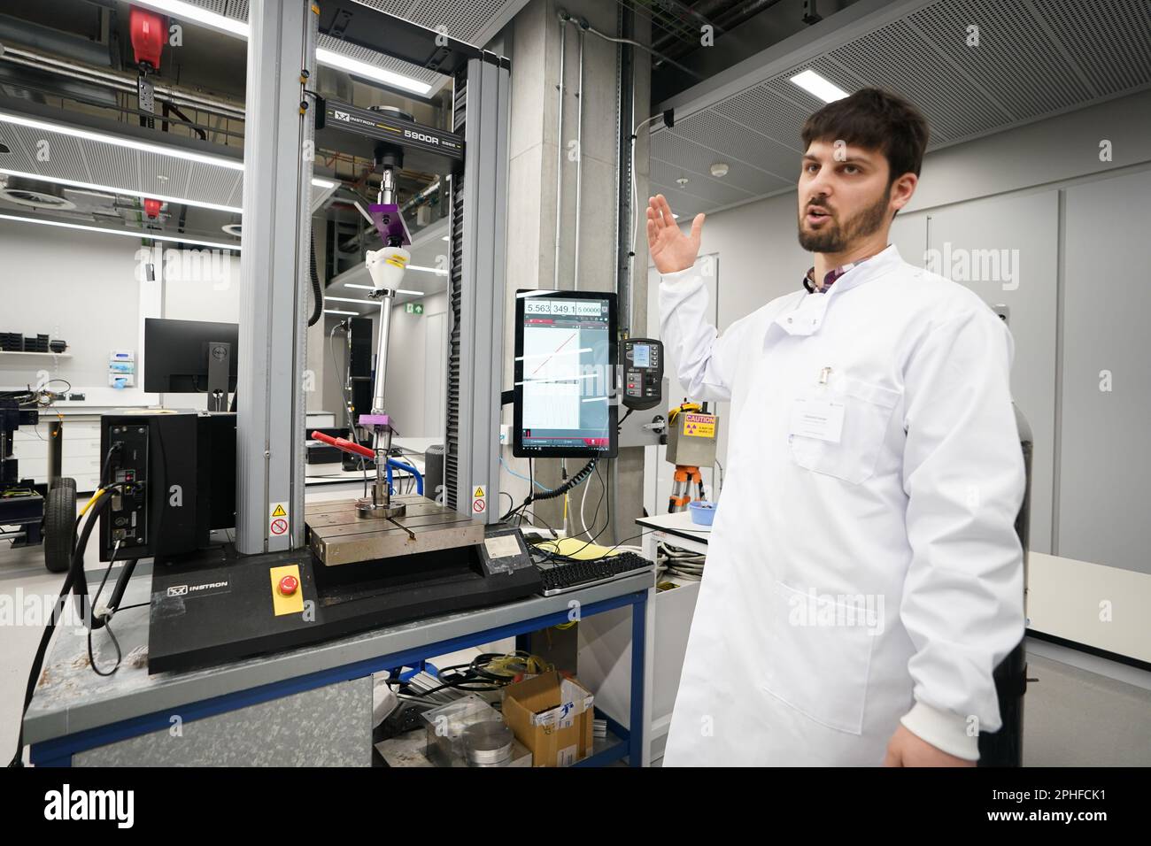 A researcher demonstrates a machine used to stress test prosthetics ...