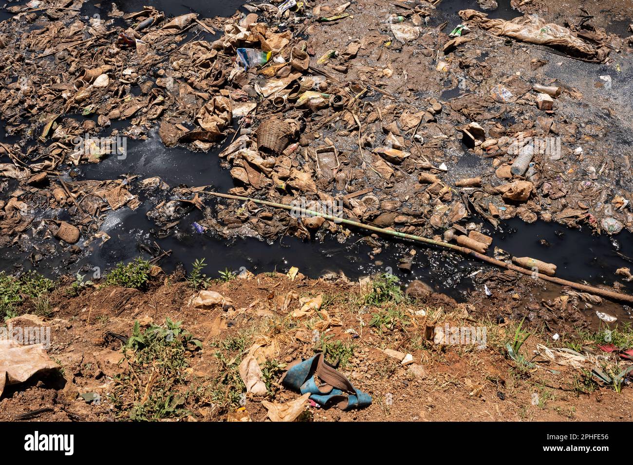 View of a polluted river that passes through Kibera slum, Nairobi ...