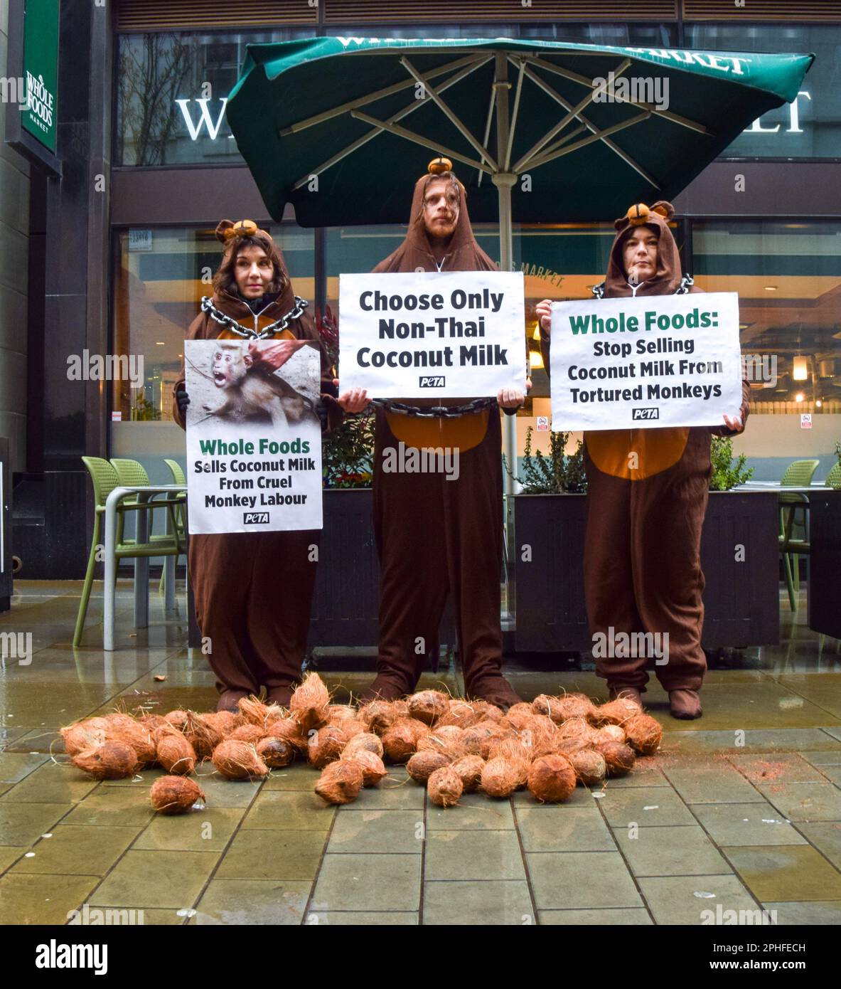 London, UK. 28th March 2023. PETA activists dressed as chained monkeys ...
