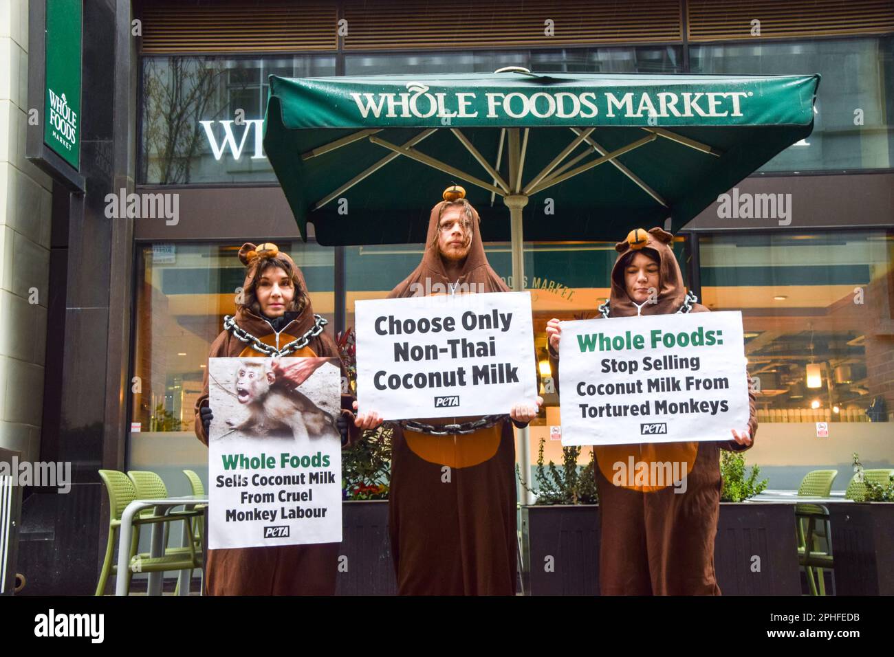 London, UK. 28th March 2023. PETA activists dressed as chained monkeys ...