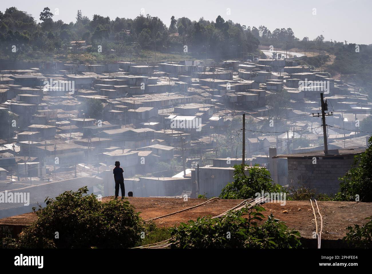 A child standing in front of Kibera shacks. Kibera is the biggest slum ...