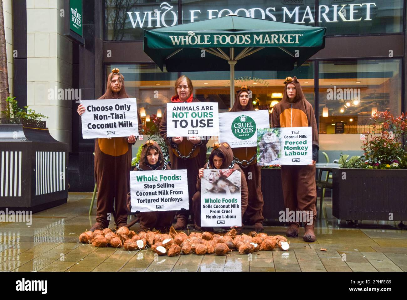 London, UK. 28th March 2023. PETA activists dressed as chained monkeys ...