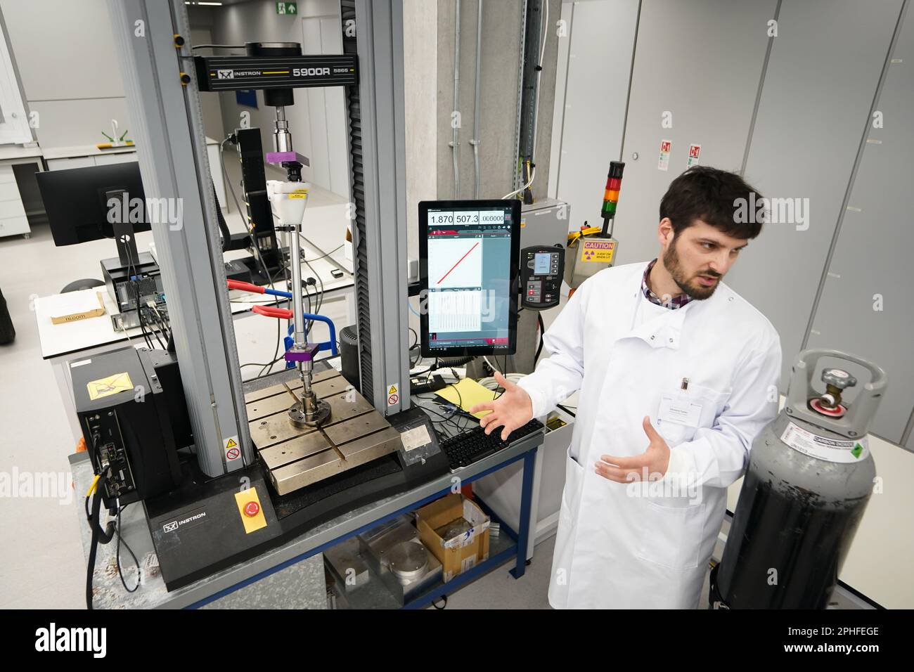 A researcher demonstrates a machine used to stress test prosthetics ...