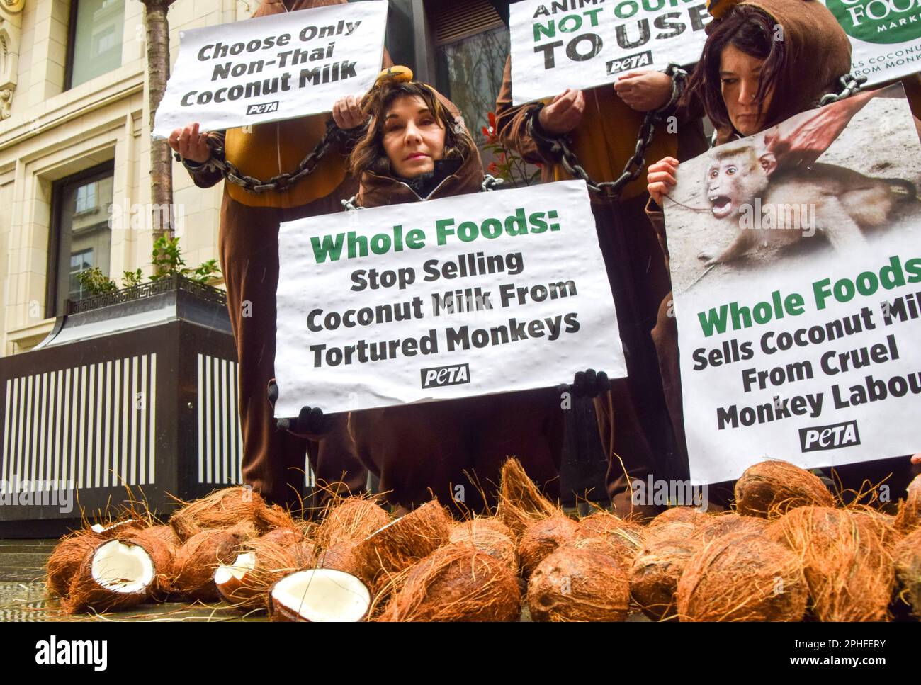 London, UK. 28th March 2023. PETA activists dressed as chained monkeys ...