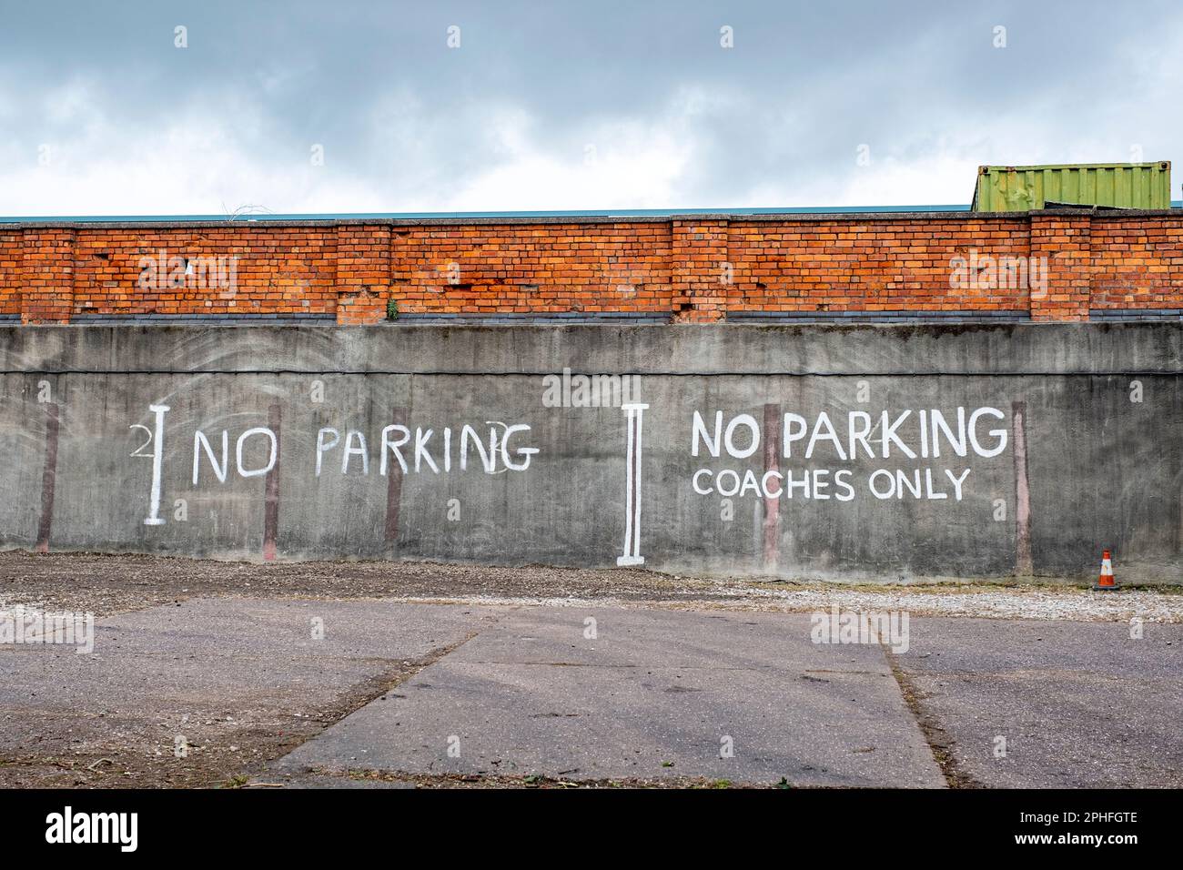 No Parking coaches only, traffic warning sign painted on concrete wall ...