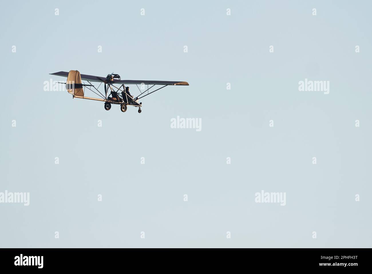 Plane flying high up in the cloudless sky at daytime. Male pilot Stock ...