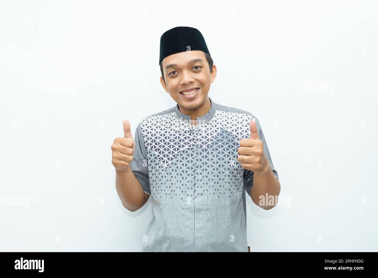 Portrait of Indonesian Asian Muslim man showing thumbs up as an appreciation gesture Stock Photo ...