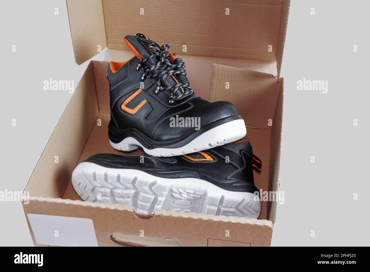 Safety shoes in a cardboard box. Close-up. On white background Stock ...