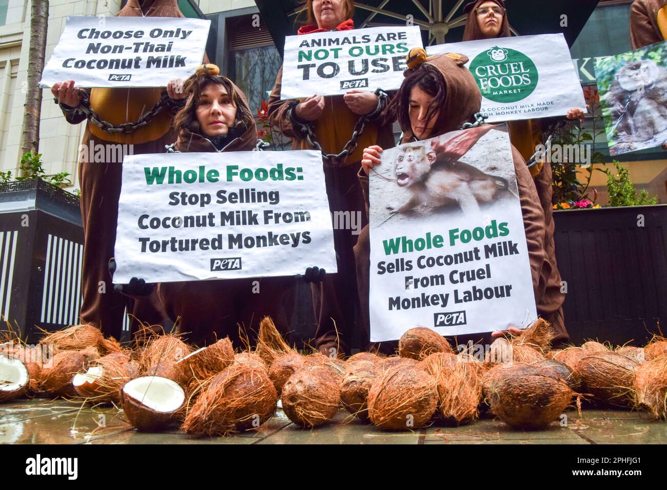 London, England, UK. 28th Mar, 2023. PETA activists dressed as chained ...