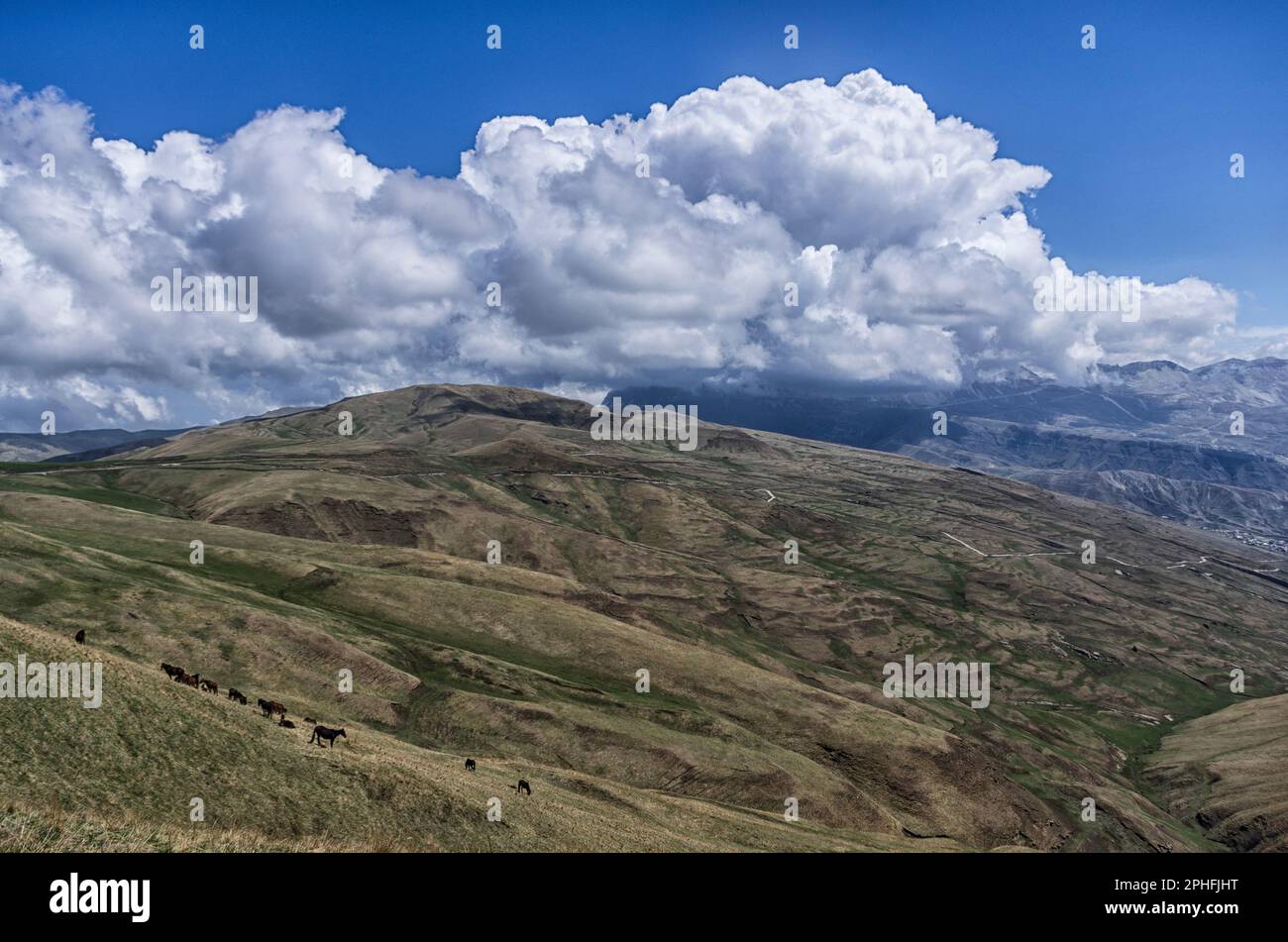 A scenic view of a mountainous landscape with rolling hills covered in ...